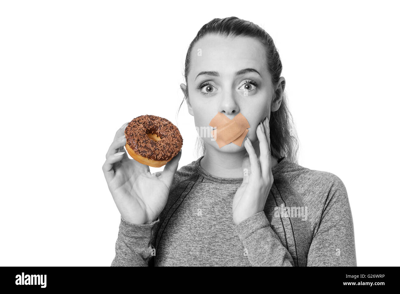 woman with first aid plaster over mouth unable to eat a donut Stock ...