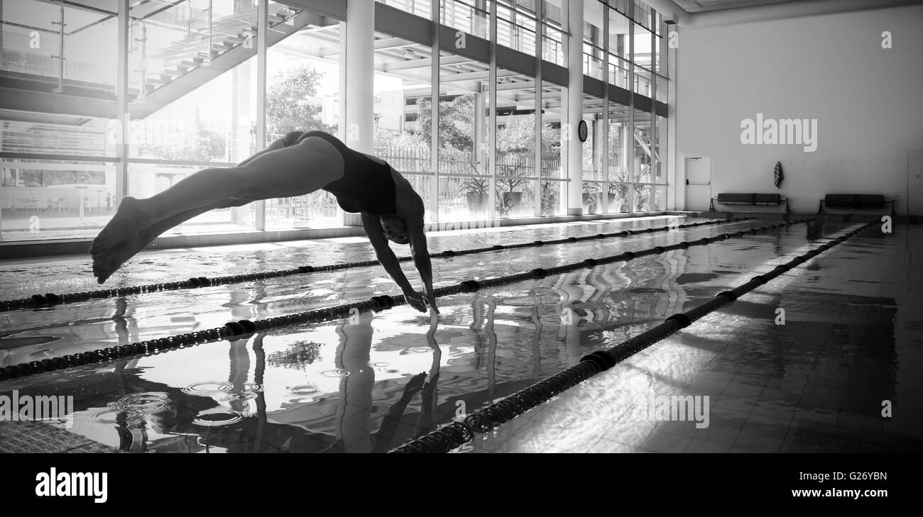 Woman diving in swimming pool Stock Photo - Alamy
