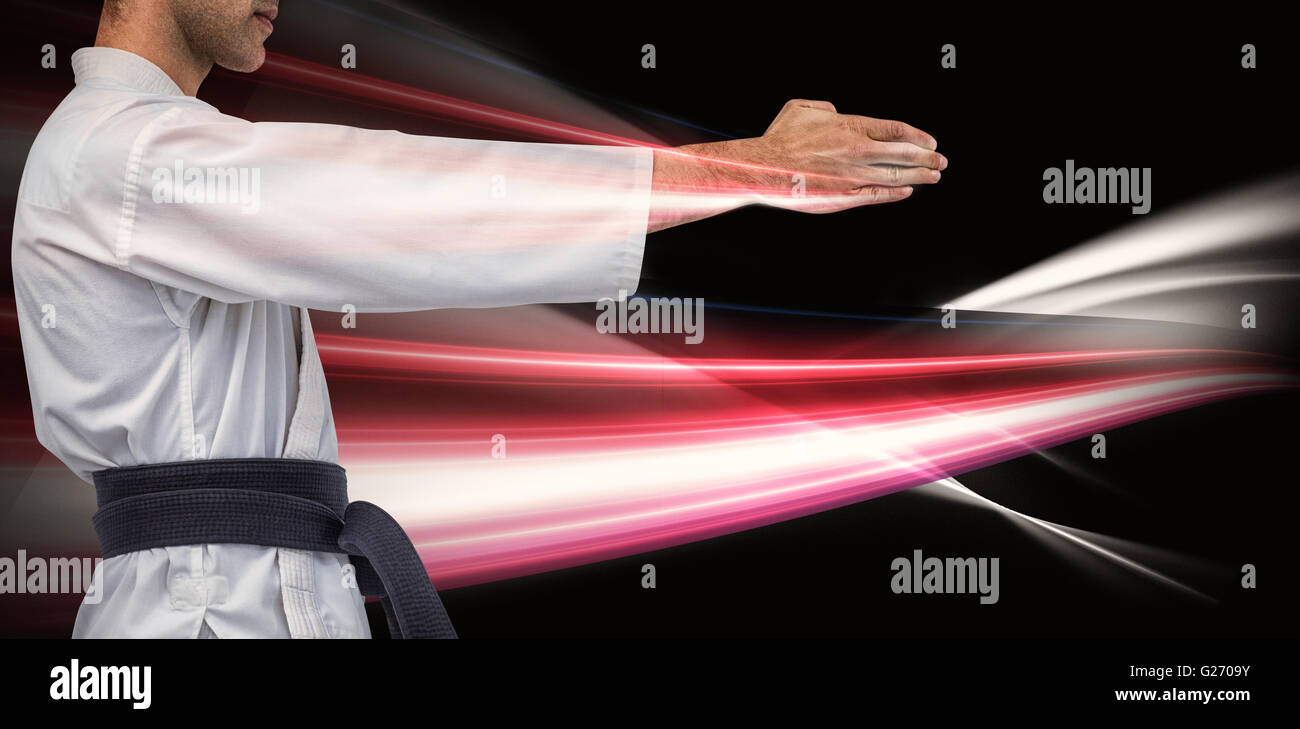 Composite image of mid section of fighter performing karate stance ...
