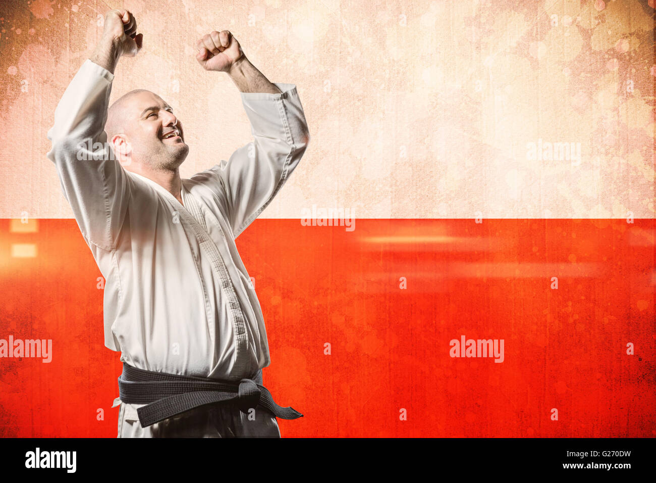 Composite image of fighter posing after victory Stock Photo - Alamy