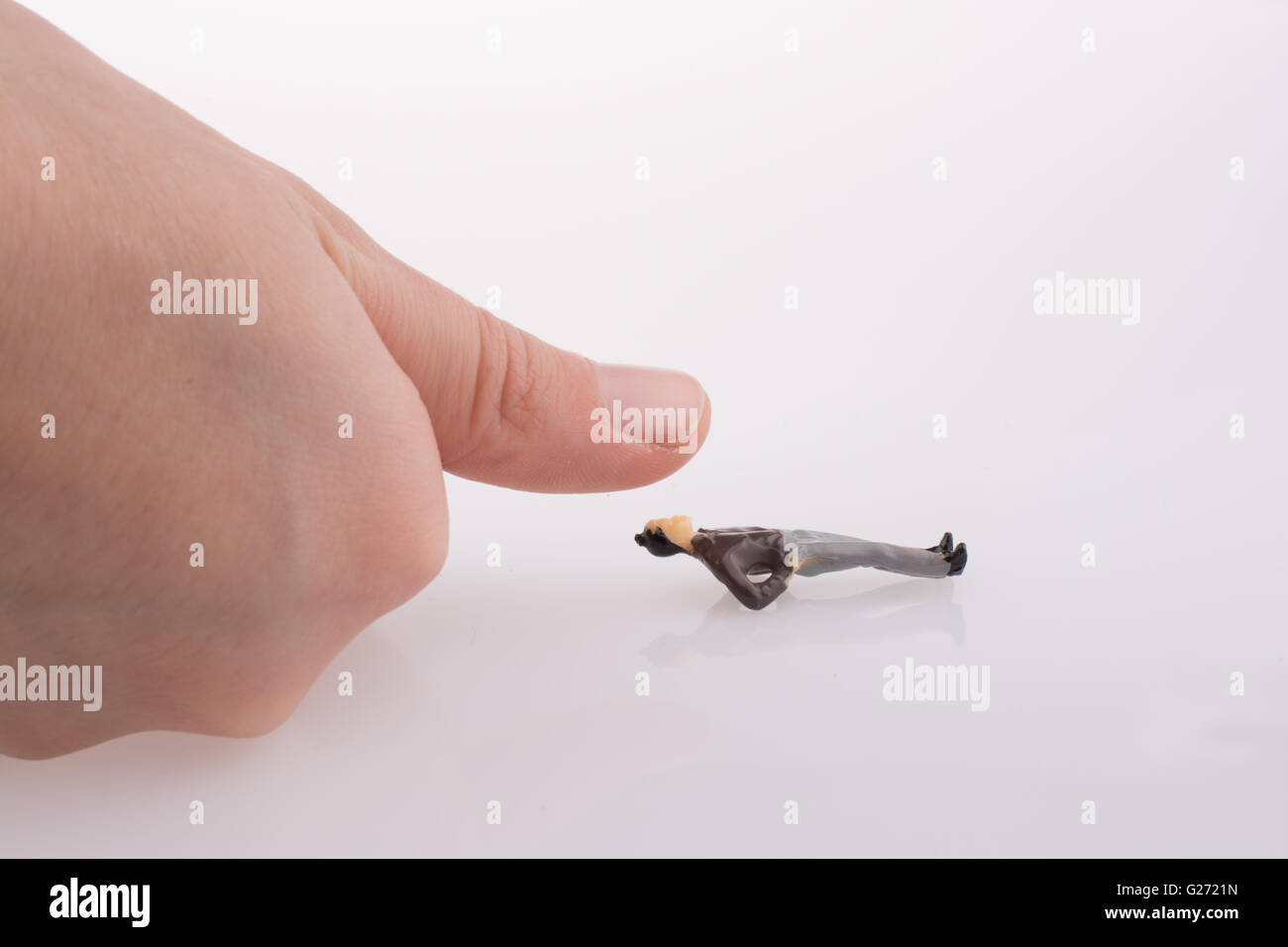 Hand threating to smash human figure on a white background Stock Photo ...