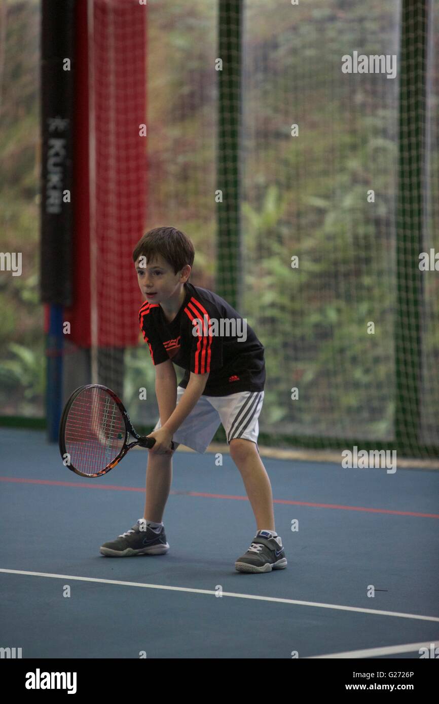 Young junior male tennis player ready to receive serve during tennis ...