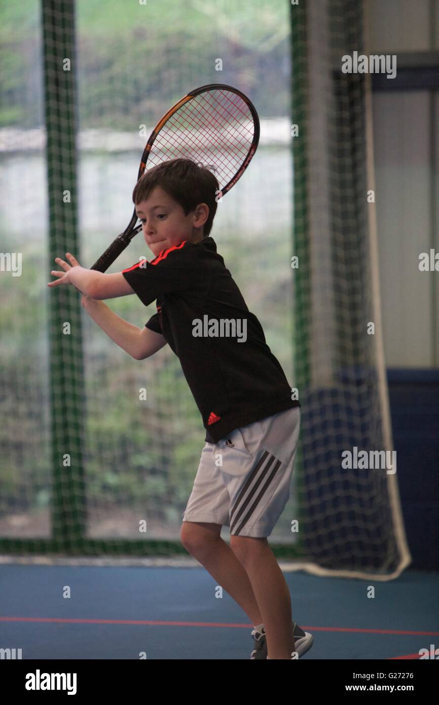 Young boy playing tennis about to hit his forehand Stock Photo - Alamy