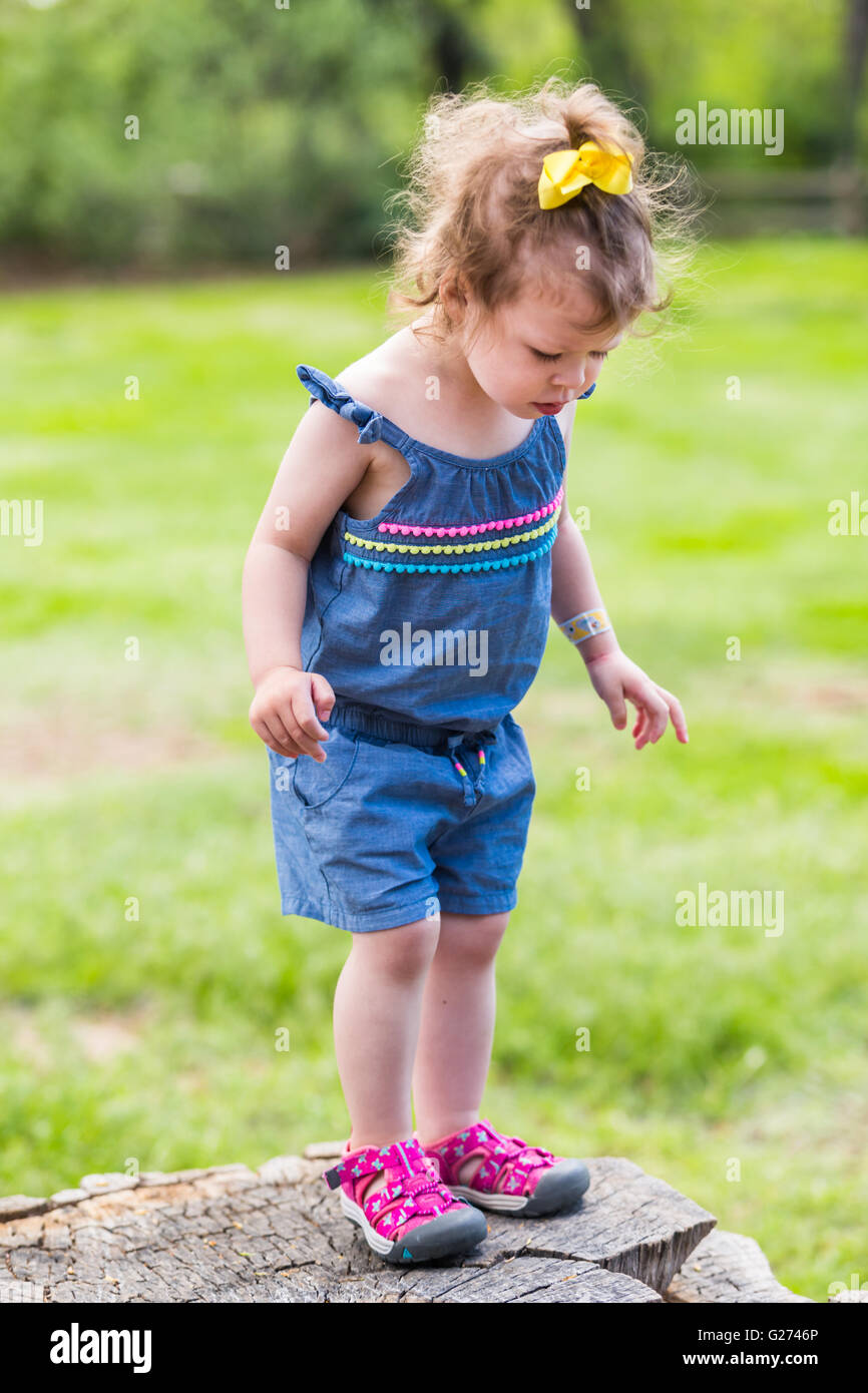 Toddler playing outsine in the Summer Stock Photo - Alamy