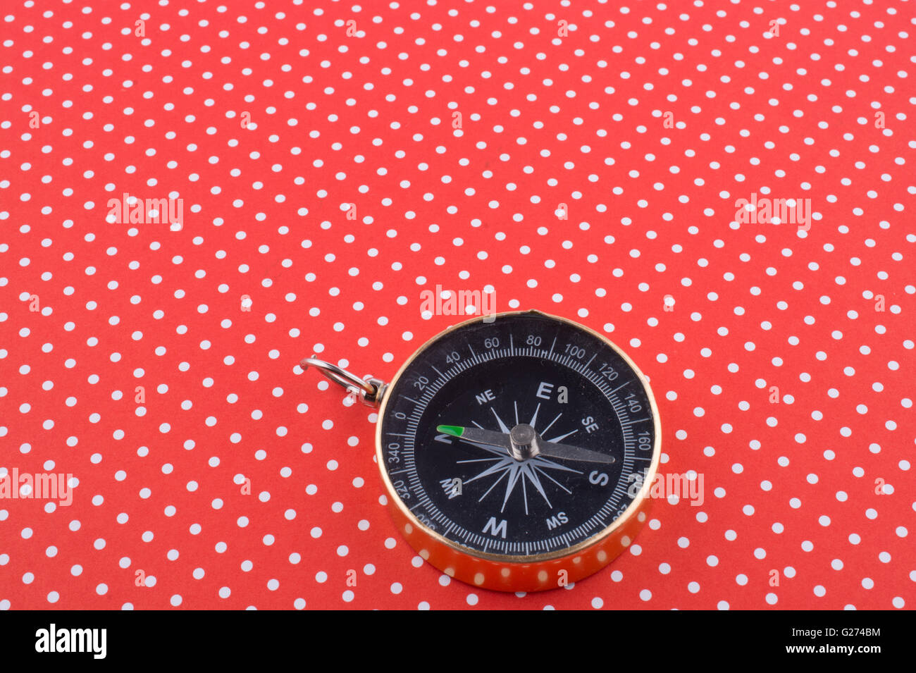 Retro Compass on a red background Stock Photo - Alamy