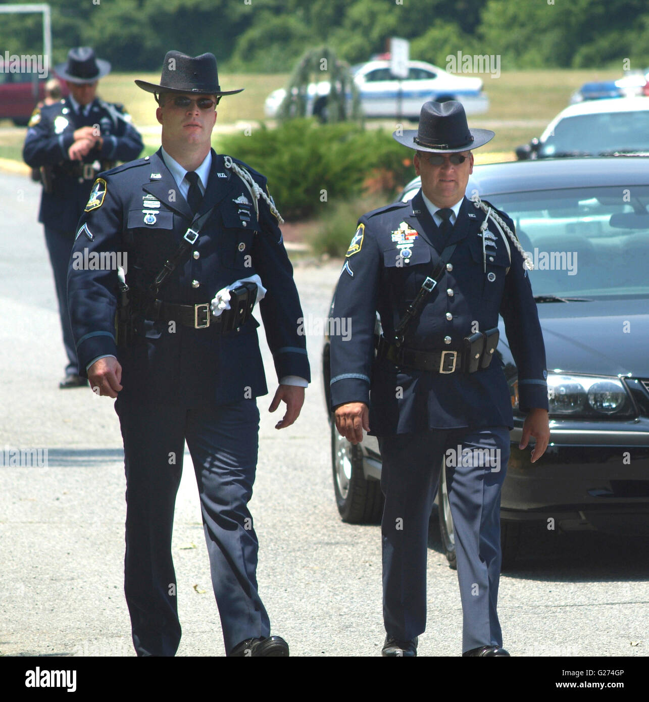 Police officers walking down street Stock Photo - Alamy