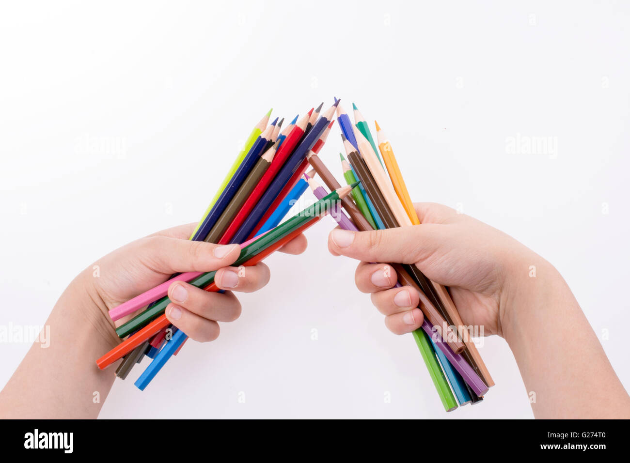 Hand holding color pencils on a white background Stock Photo - Alamy