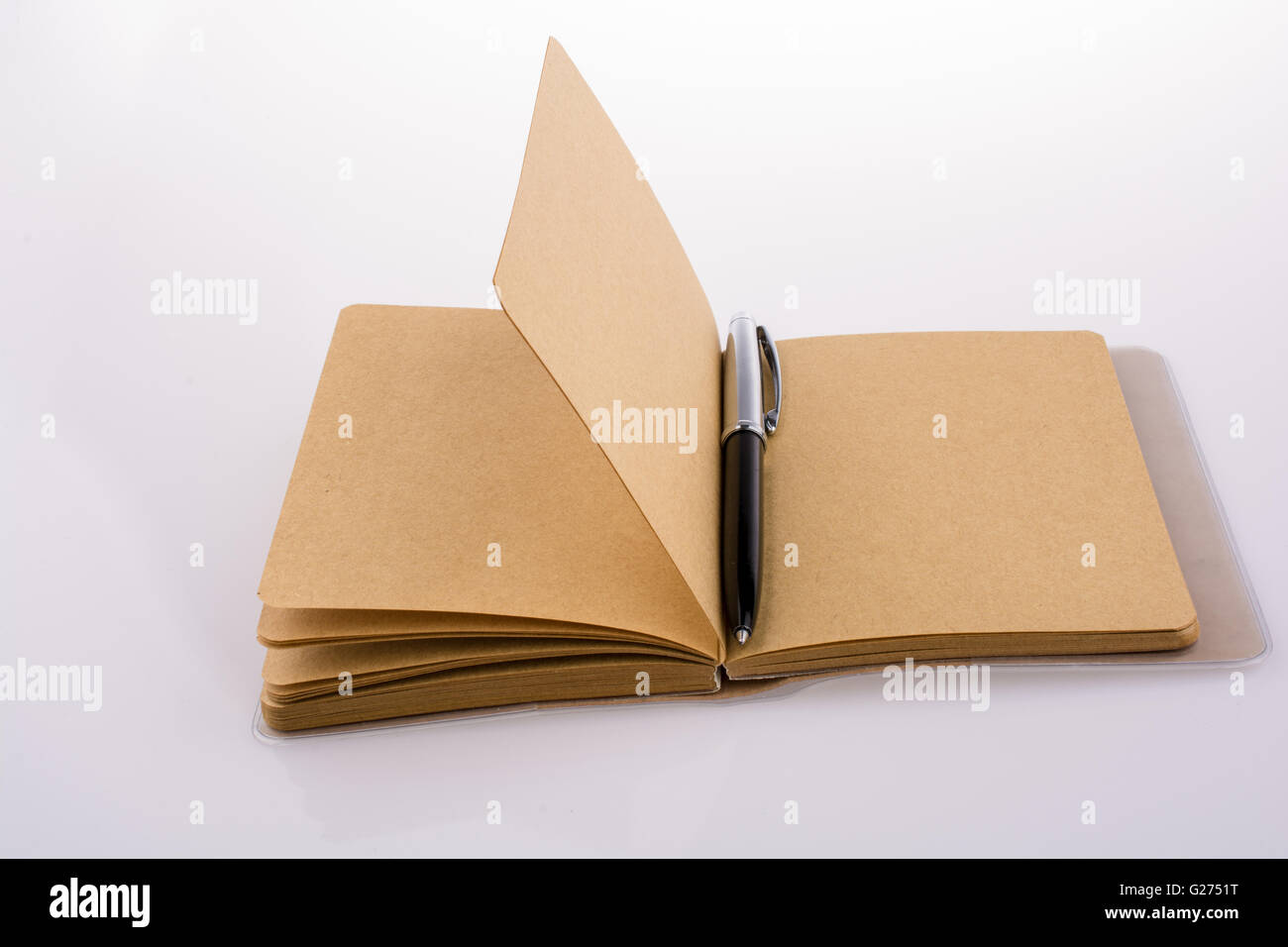 Pen on a notebook on a white background Stock Photo - Alamy