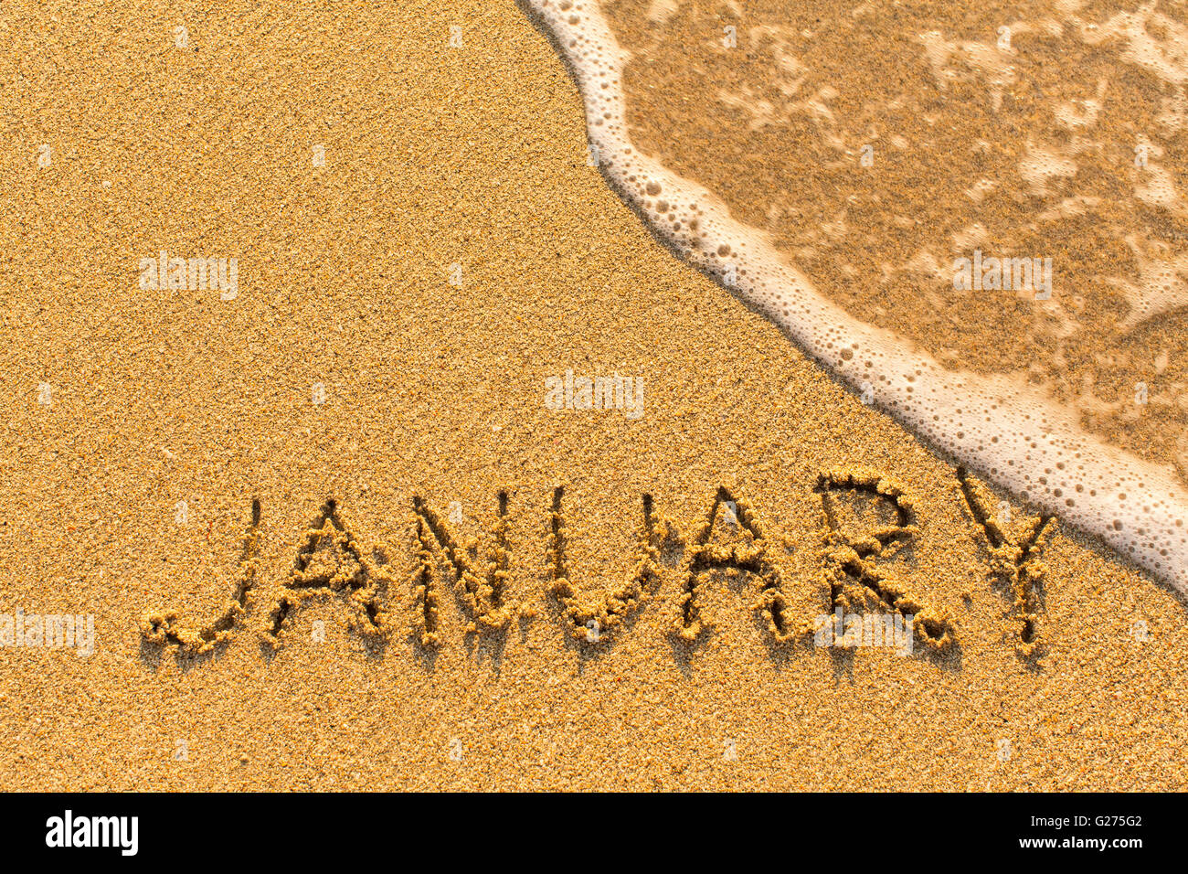 January - written by hand on a golden beach sand Stock Photo - Alamy