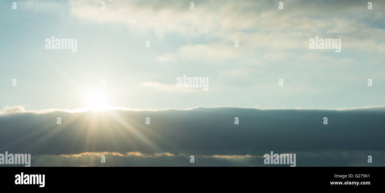 Sun behind beautiful white clouds in midday Stock Photo - Alamy