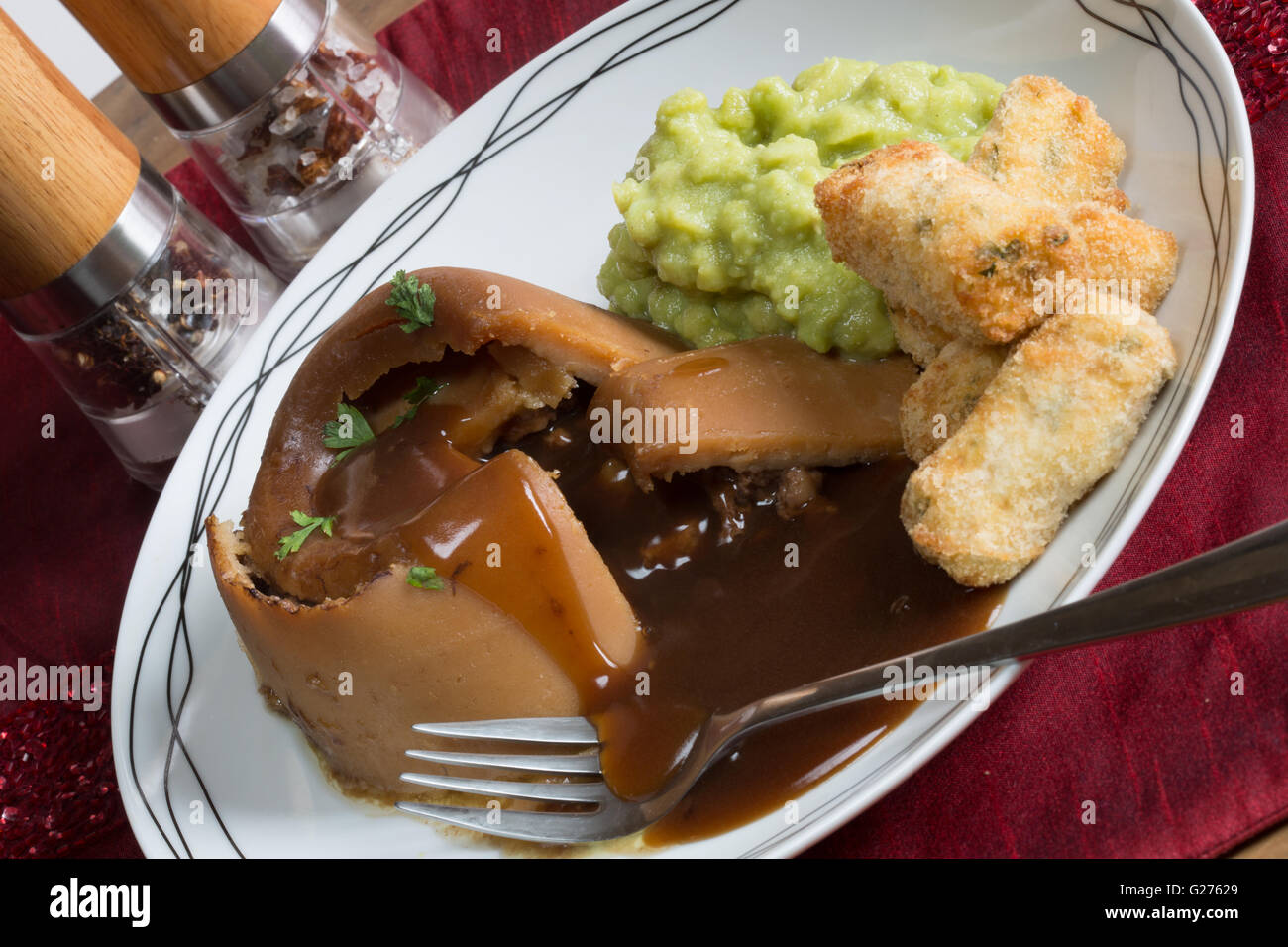 A classic English dish of Steak and Kidney Suet Pudding served with ...