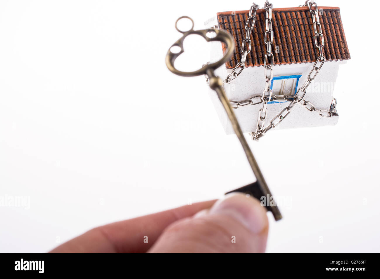 key and a house in chains on a white background Stock Photo - Alamy