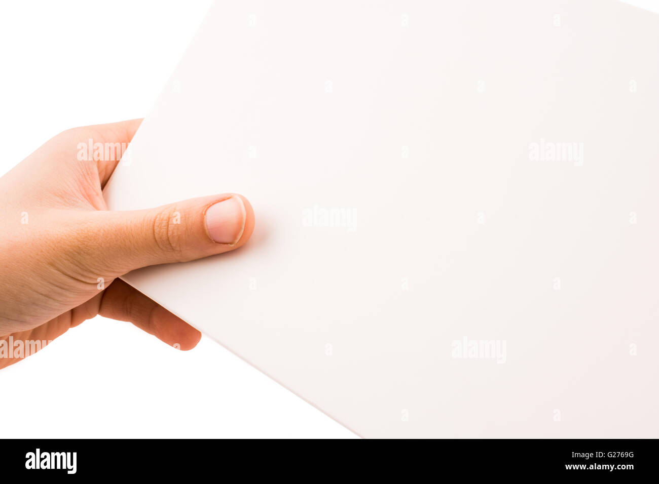 Hand holding a piece of paper on a white background Stock Photo - Alamy