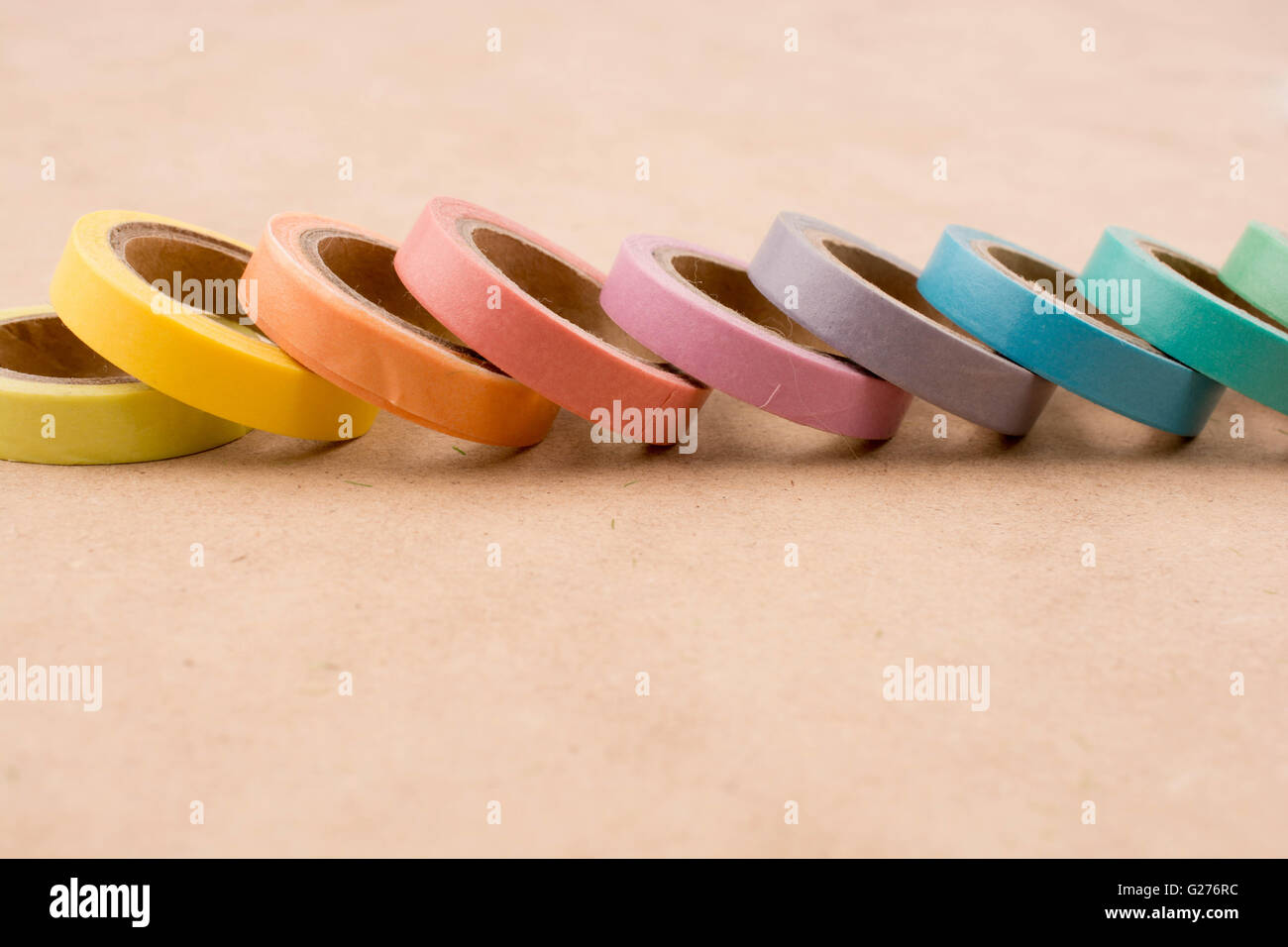 Color ribbon tapes on a wooden background Stock Photo - Alamy