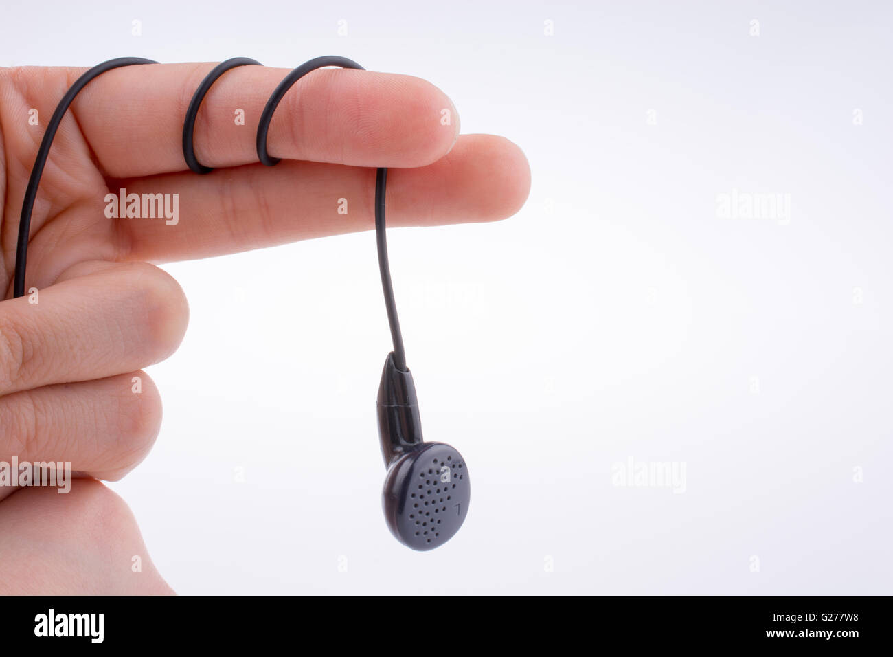Hand holding ear buds hi-res stock photography and images - Alamy