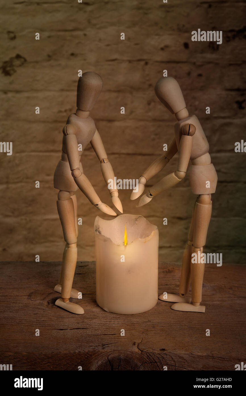 homeless dolls warming hand on fire with sick companion Stock Photo - Alamy
