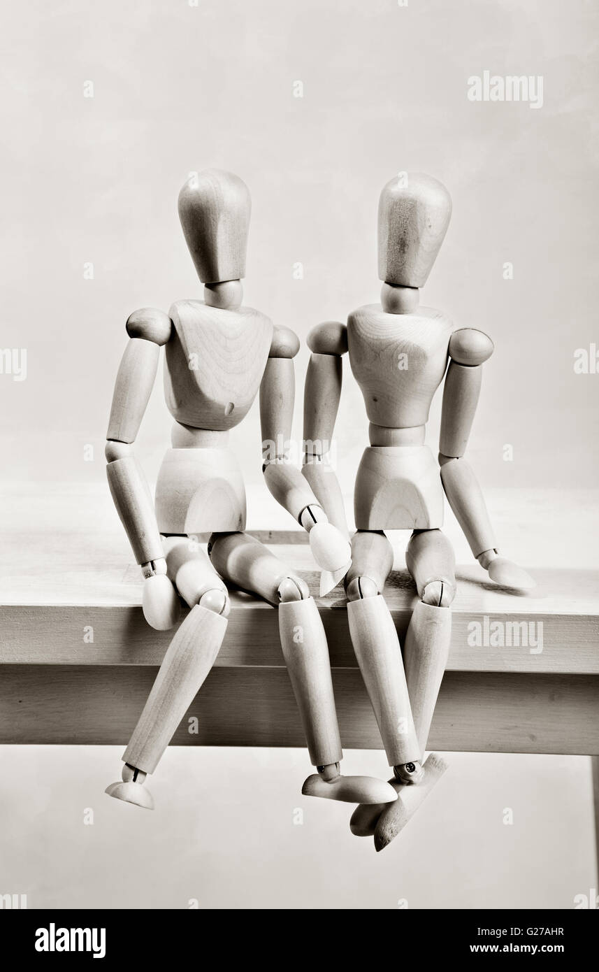Two jointed dools male and female sitting together happy Stock Photo ...