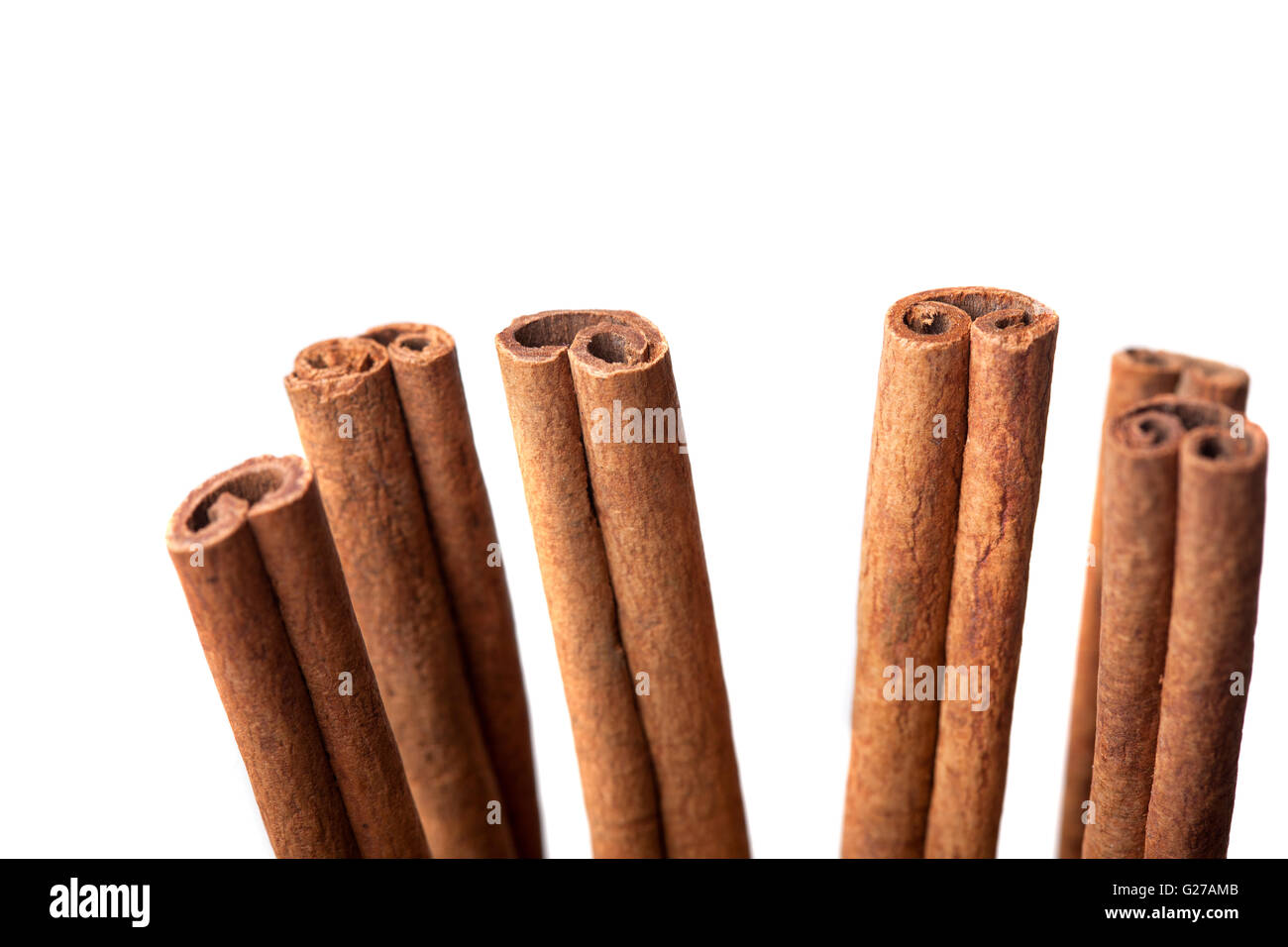 Closeup of cinnamon sticks isolated on white Stock Photo - Alamy