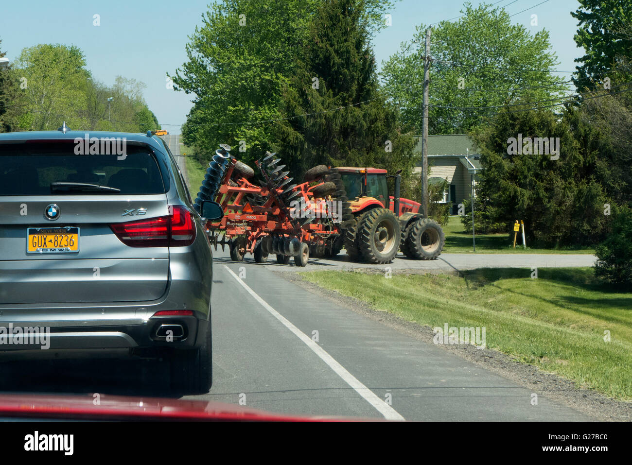 Farm machinery turning off road Stock Photo - Alamy