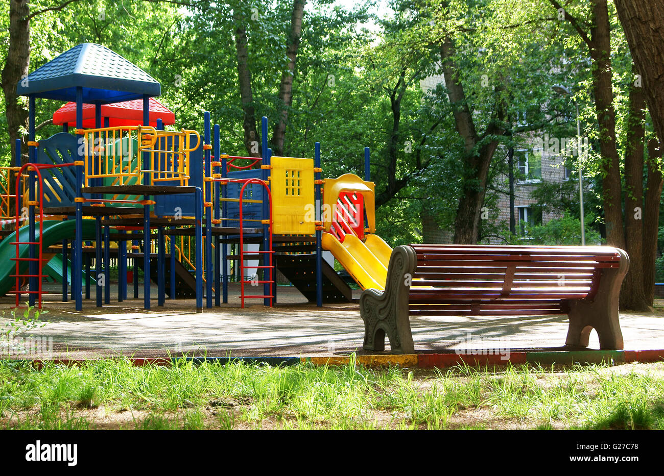 Bench and children playground Stock Photo - Alamy
