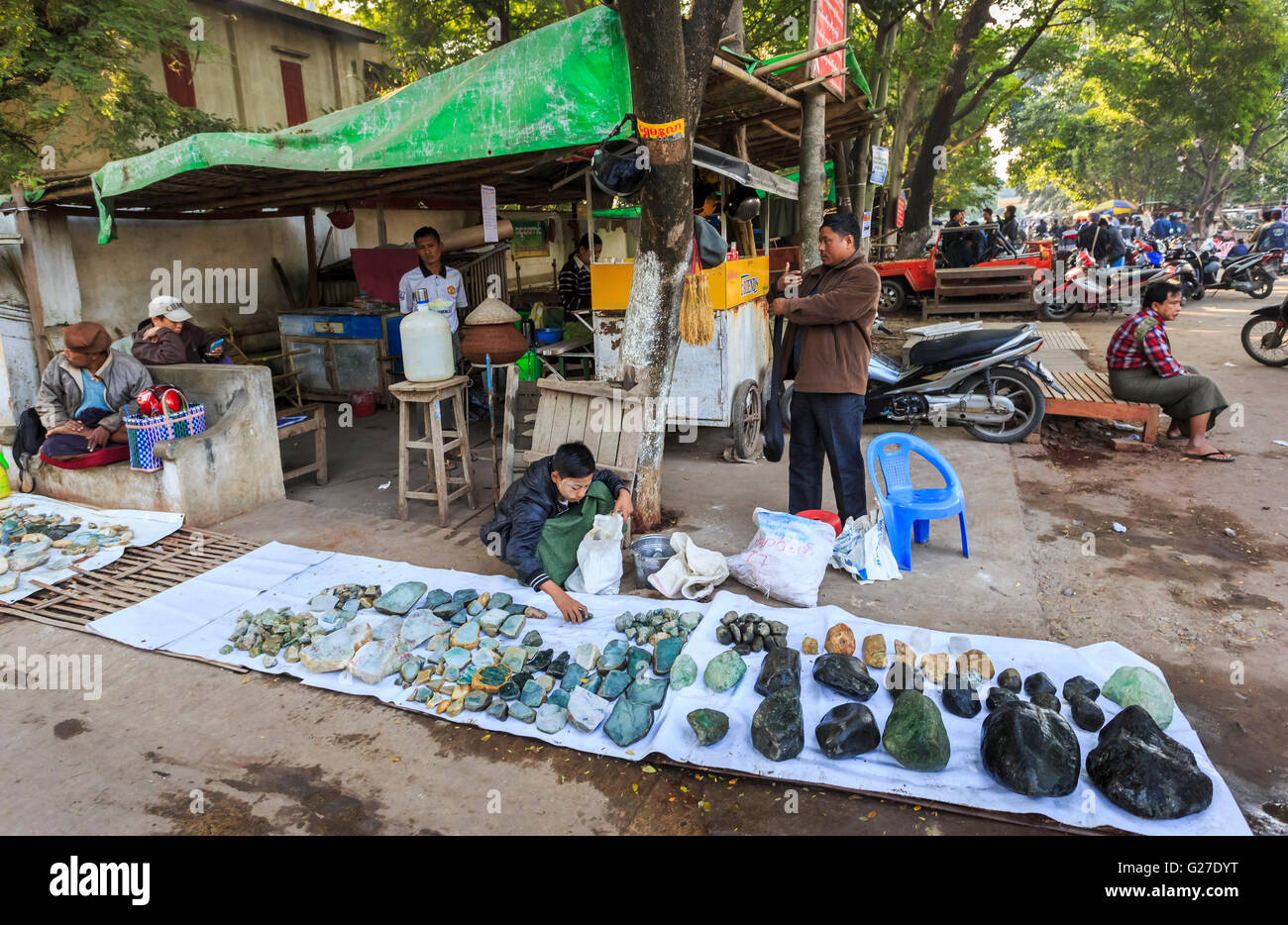 Seller arranges display of pieces of cut and polished jade on sale at ...