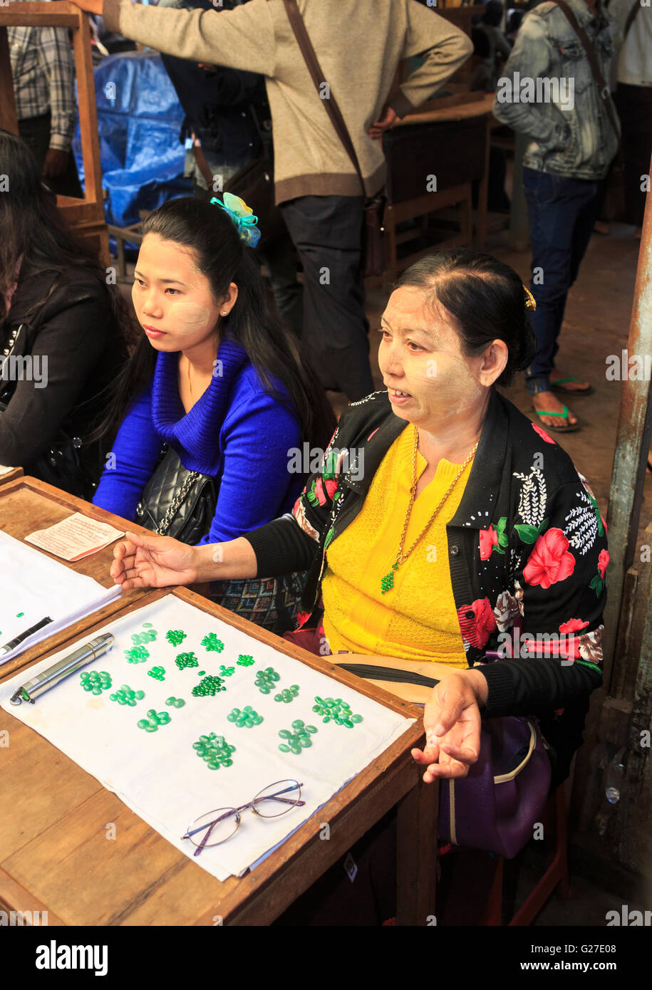 Local women stallholders wearing thanaka powder selling polished green ...