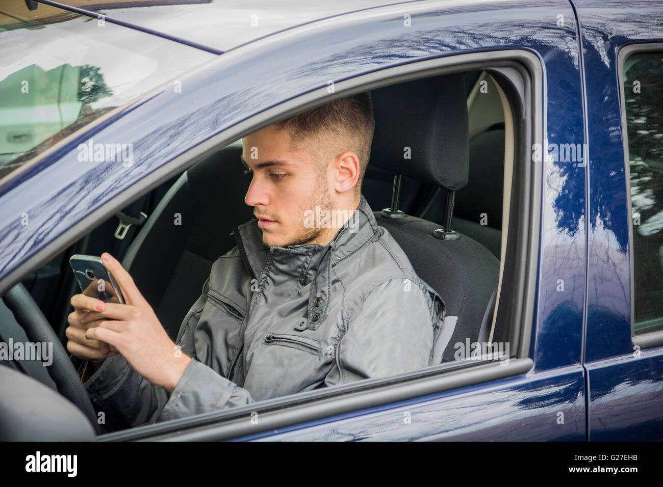 Young man driving car using hi-res stock photography and images - Alamy