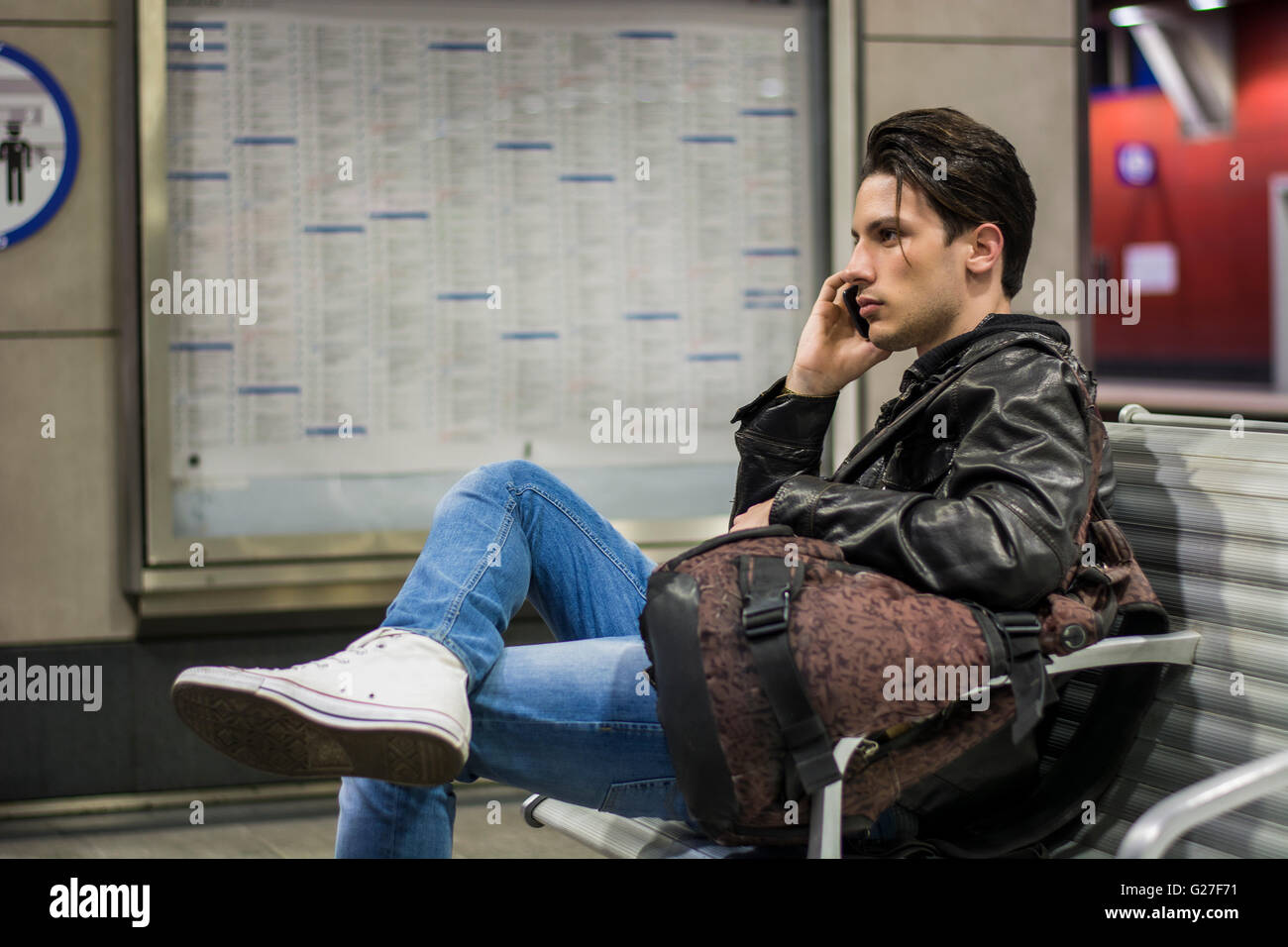 Sitting man train station hi-res stock photography and images - Alamy