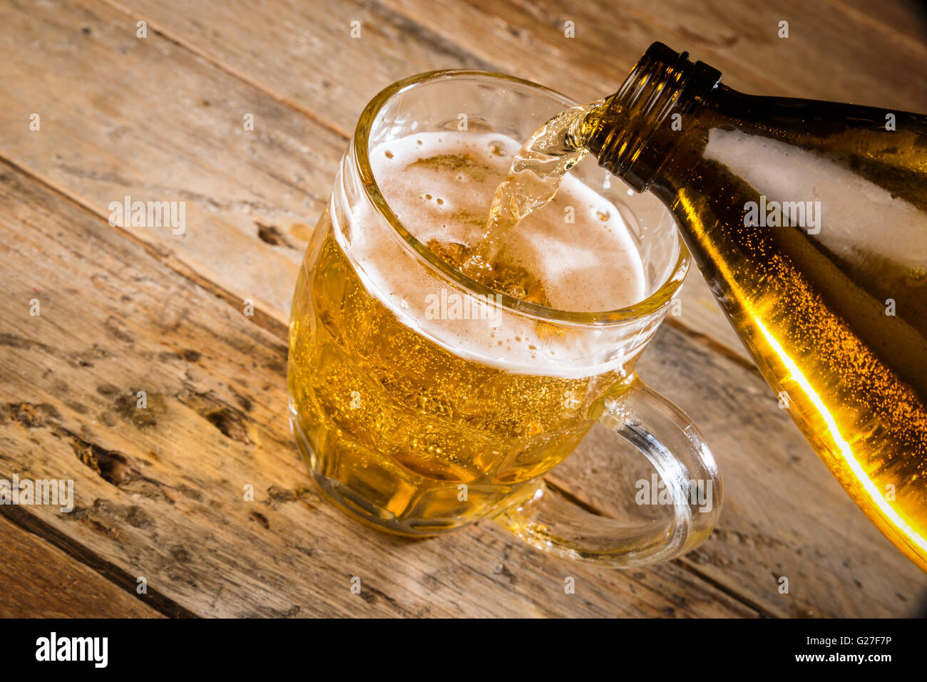 Pooring cold lager from a large bottle Stock Photo - Alamy