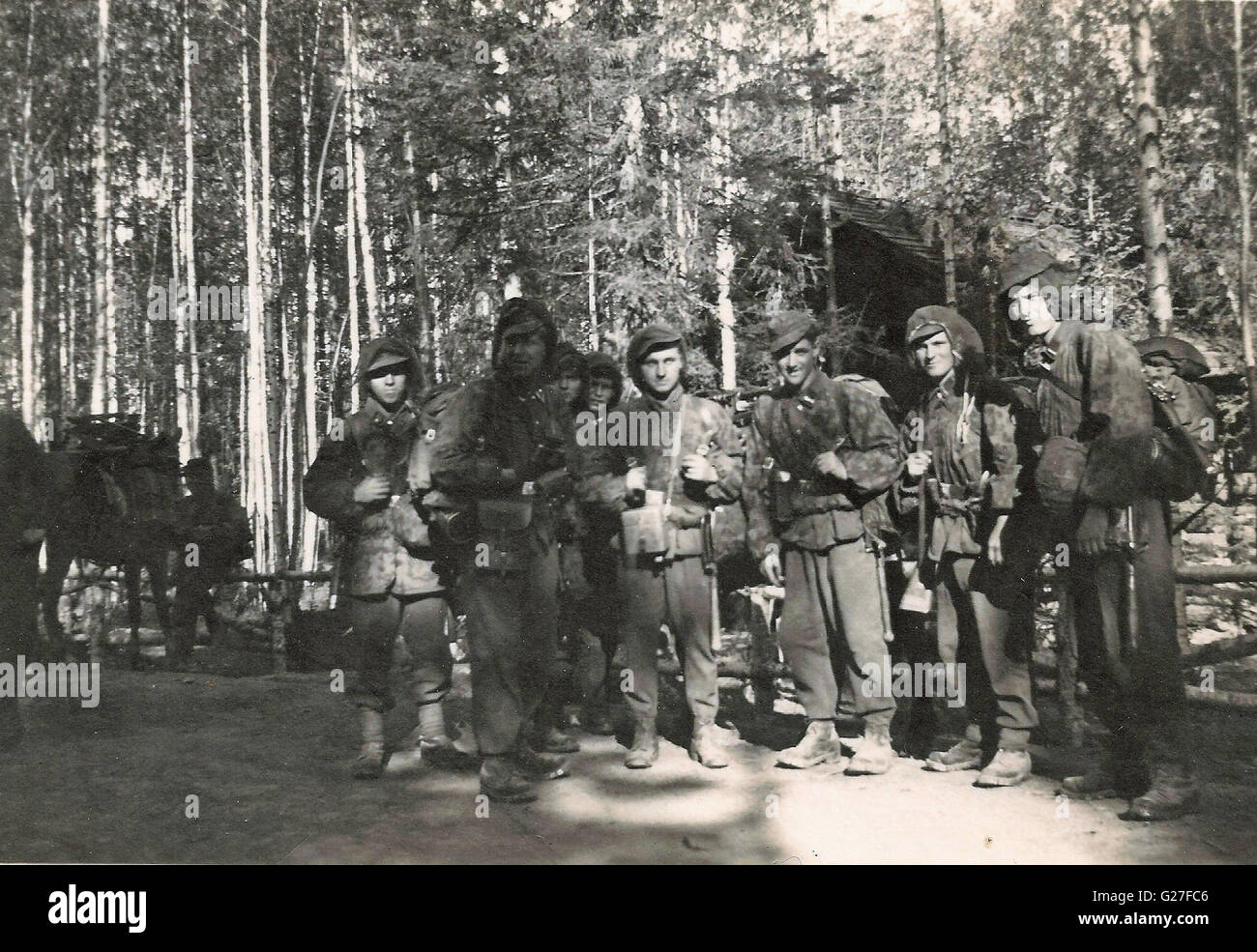 Waffen SS men in Camouflage prepare to move out in the Northern Eastern ...