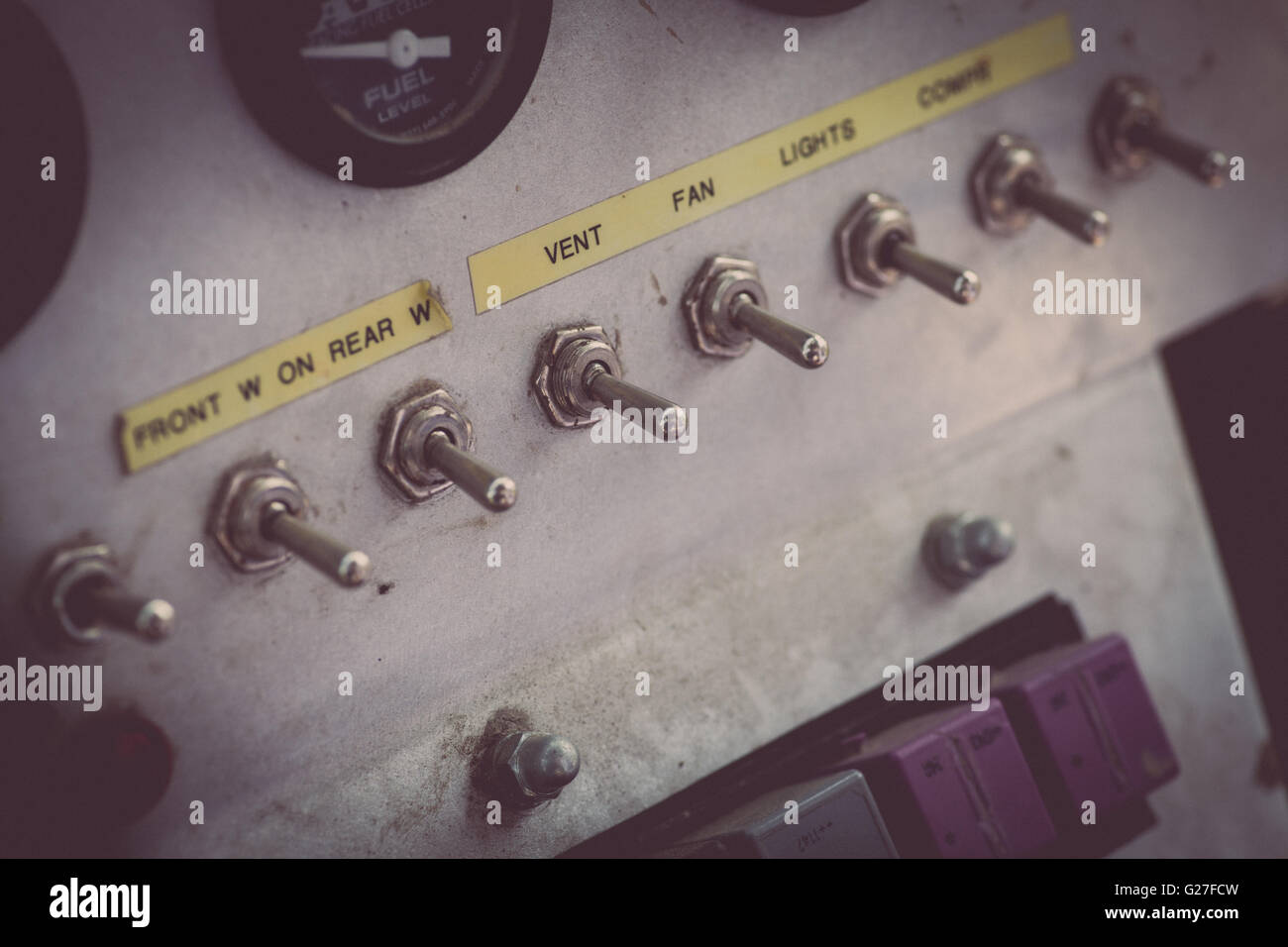 Close up shot with a line a switches on a control panel Stock Photo - Alamy