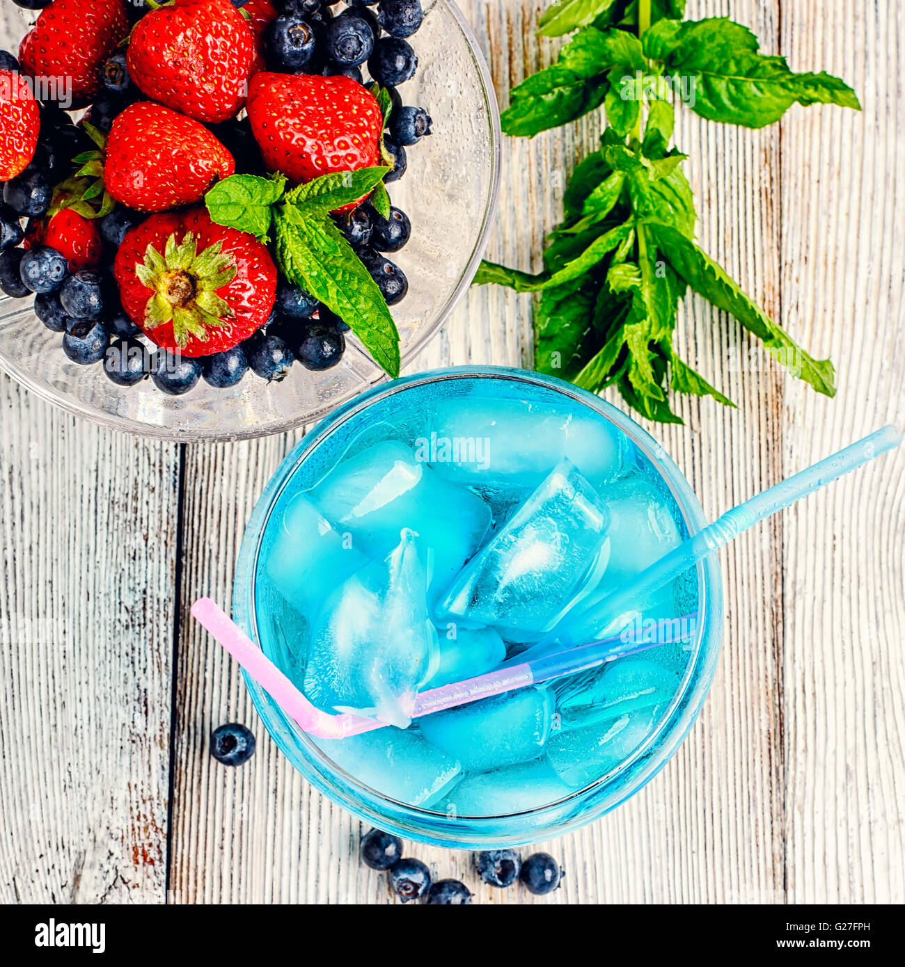 Alcohol in stylish blue color glass glass on long stalk Stock Photo - Alamy