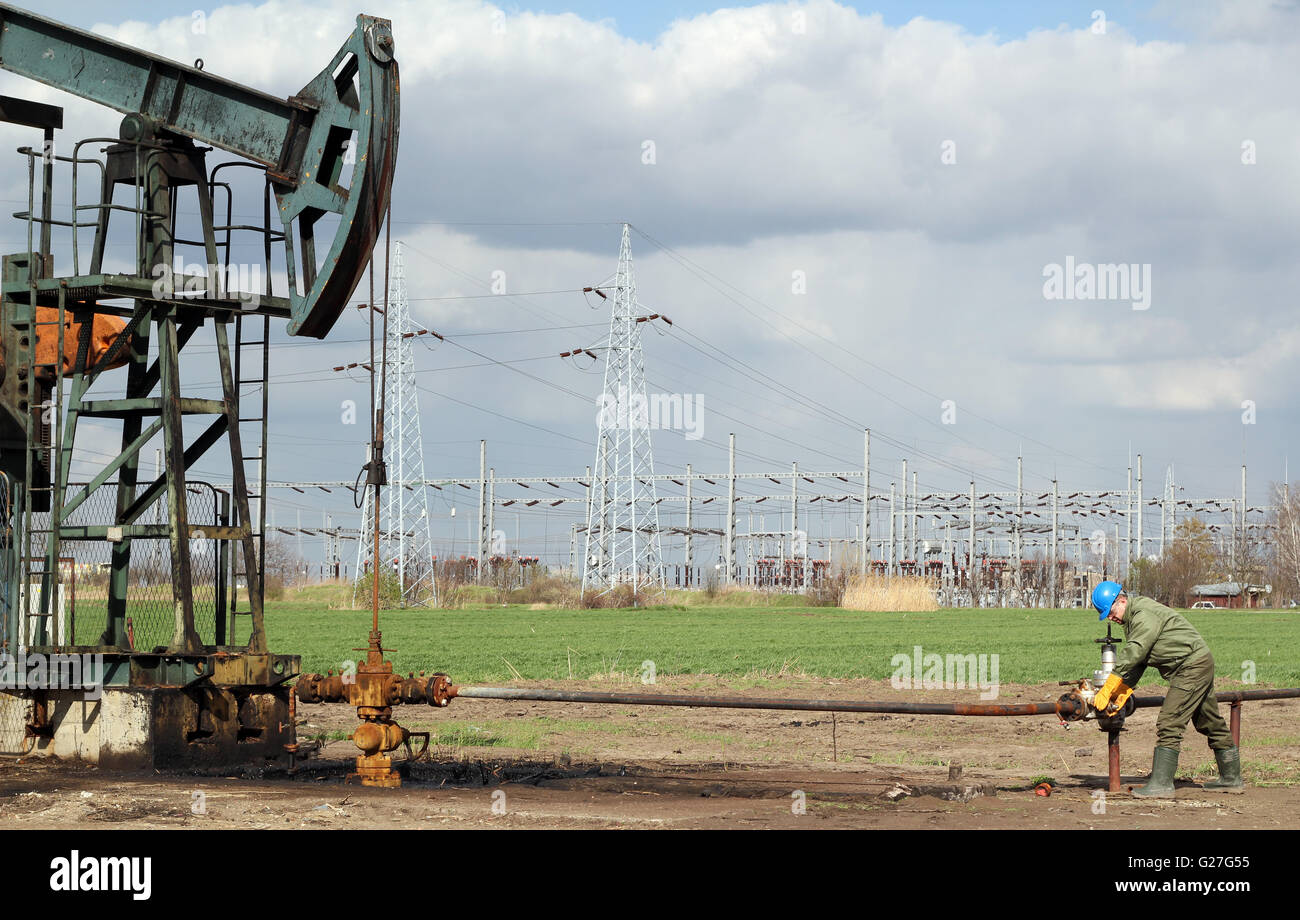 oil field with pump jack and worker Stock Photo - Alamy