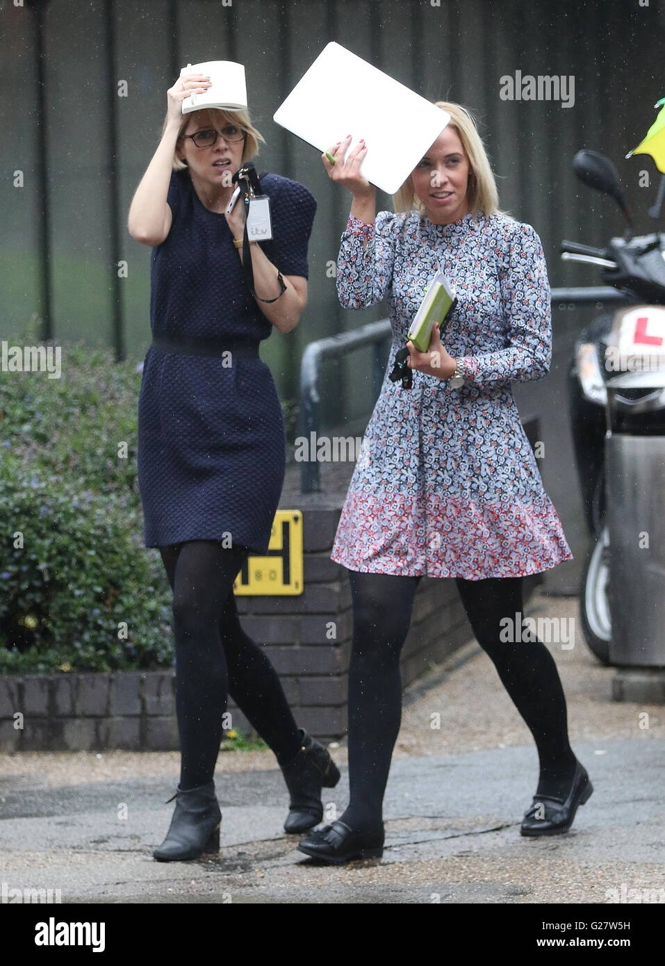 Staff leave the ITV studios following a fire drill on Monday afternoon ...