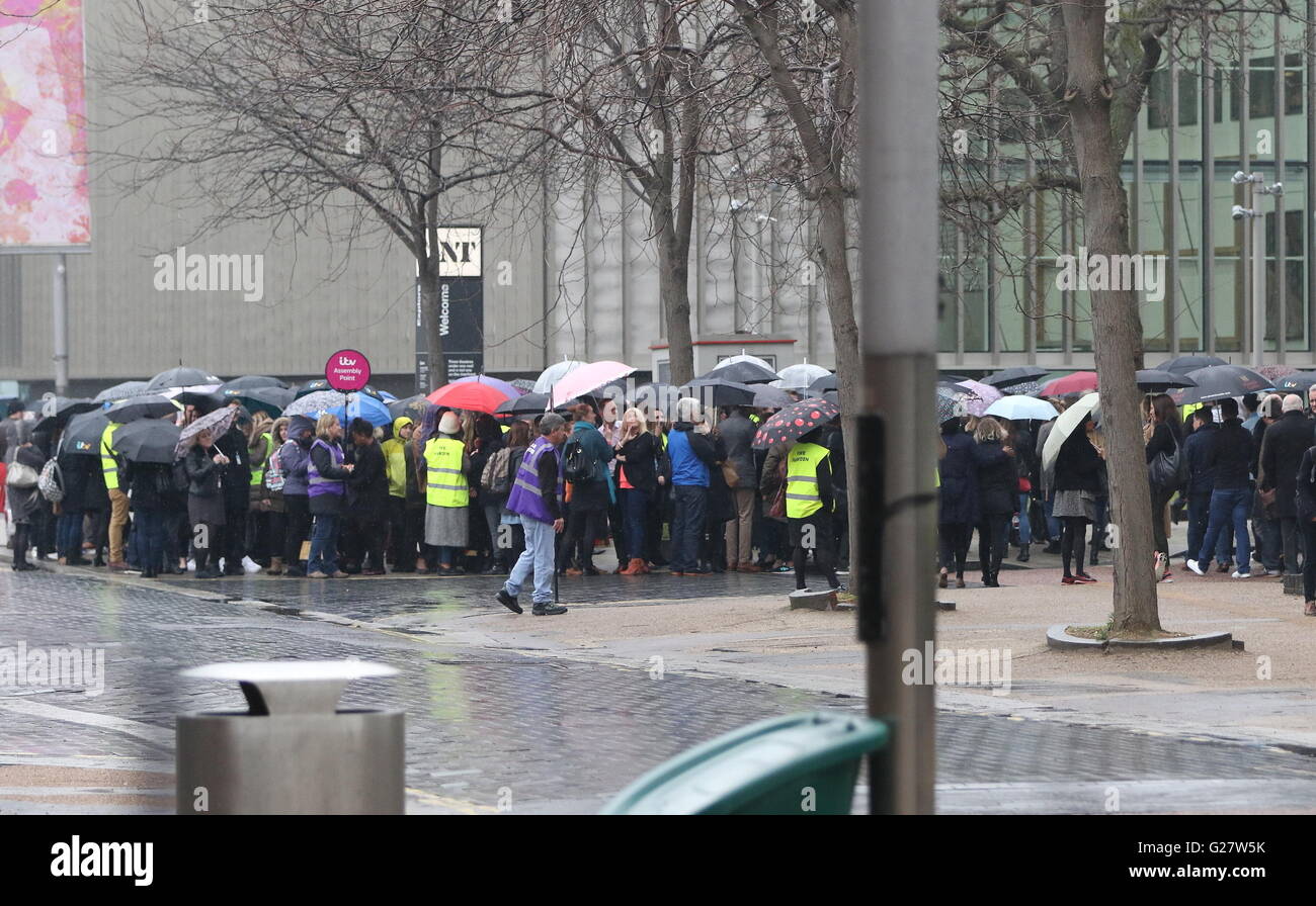 Staff leave the ITV studios following a fire drill on Monday afternoon ...