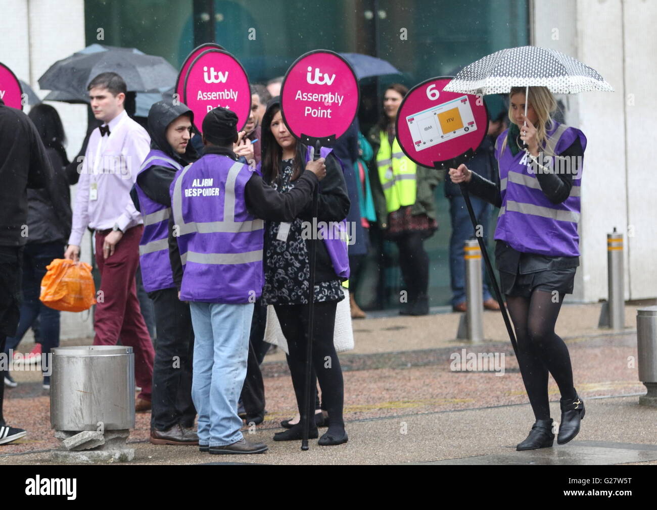 Staff leave the ITV studios following a fire drill on Monday afternoon ...