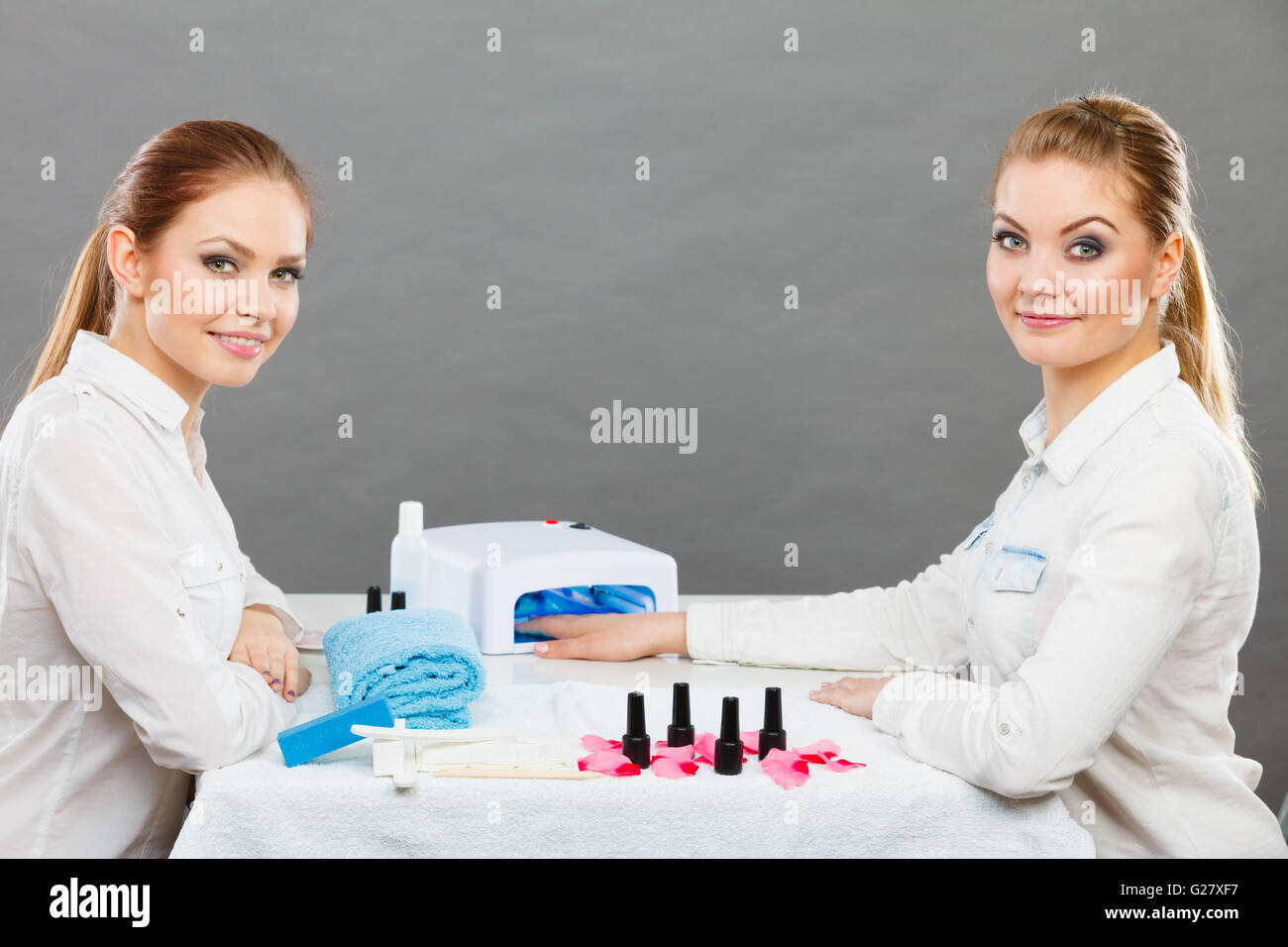 Manicure process concept. Young beautician and woman customer in beauty ...