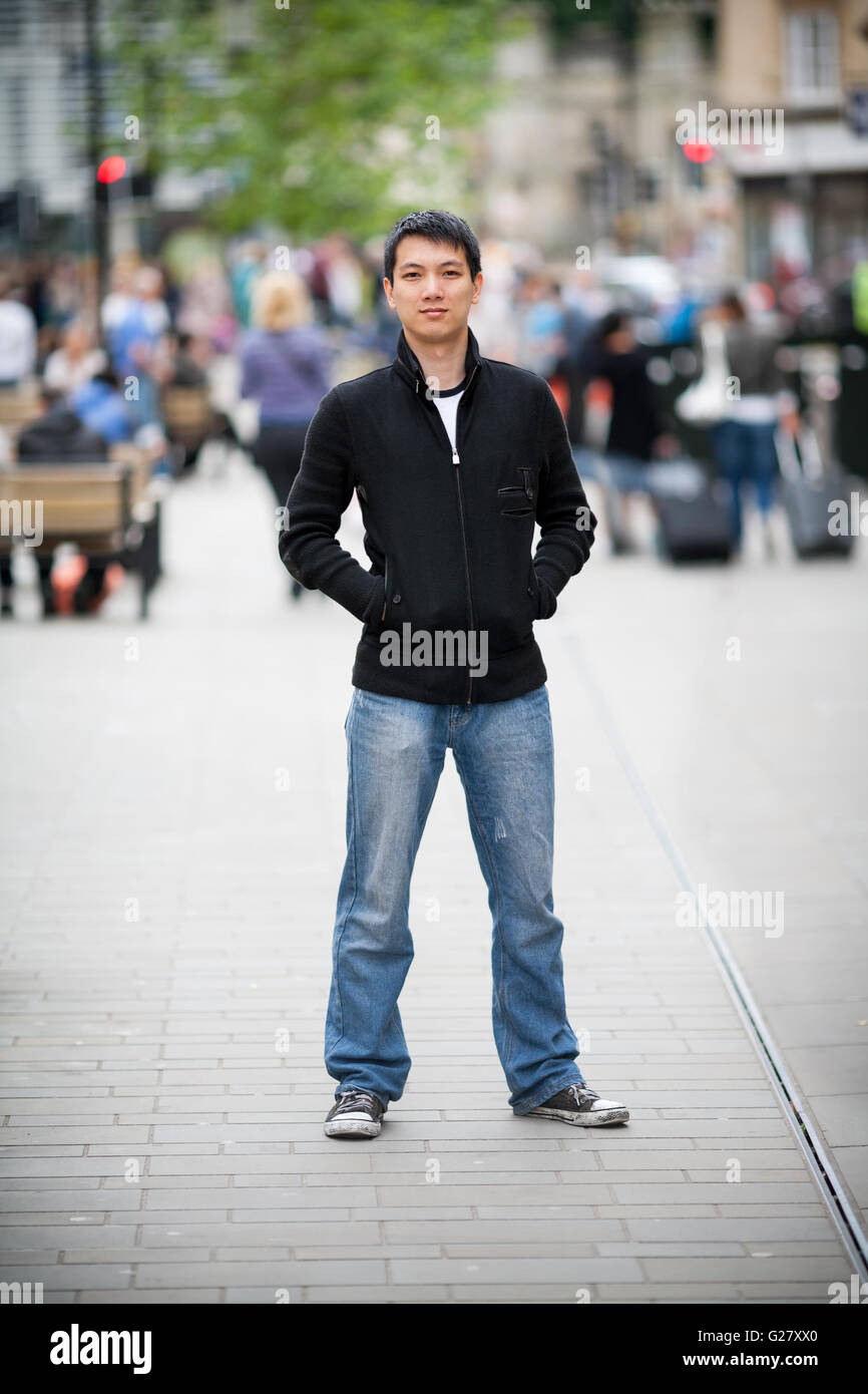 Chinese man standing on city street Stock Photo - Alamy