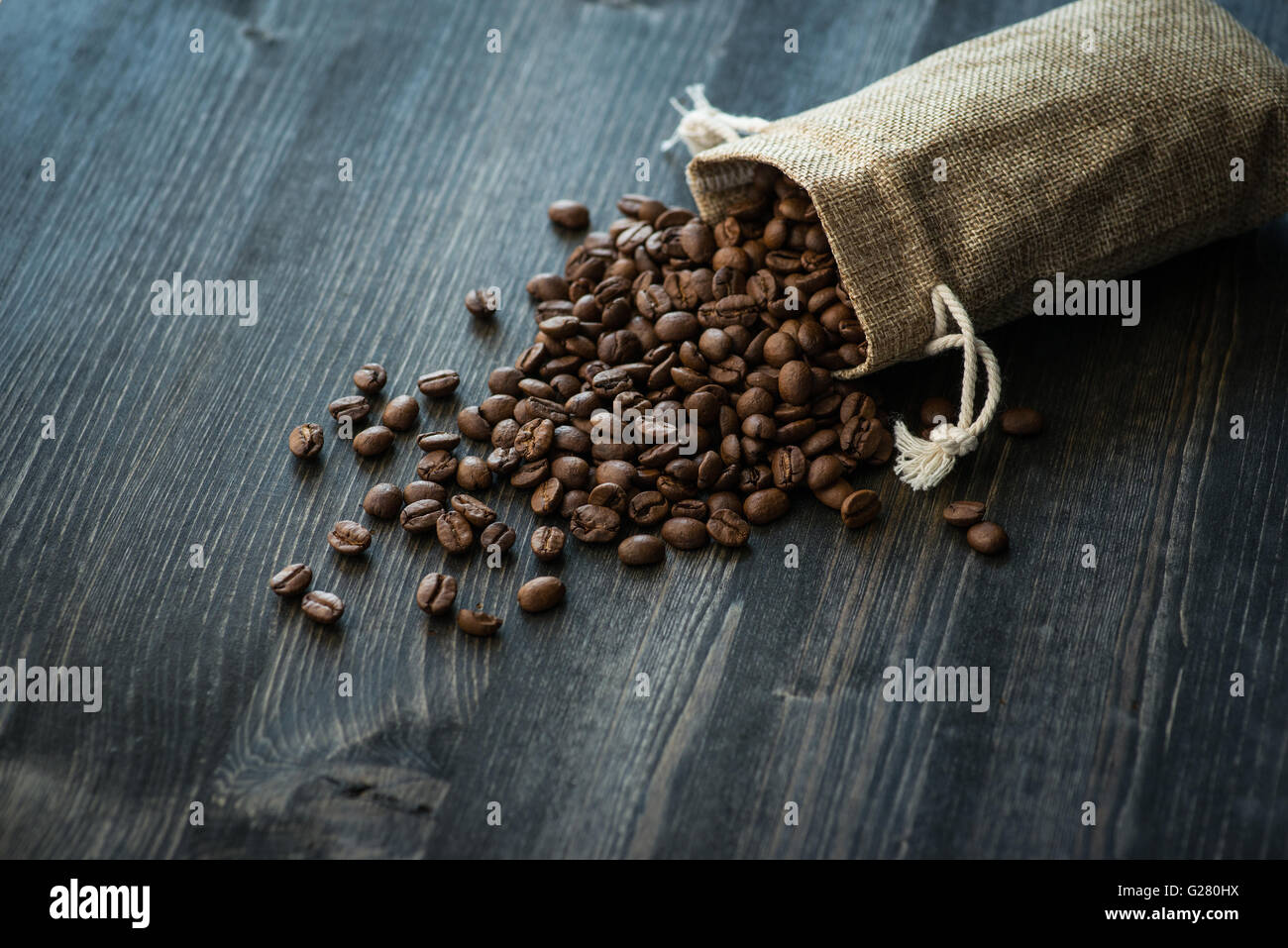 Roasted coffee beans on a rustic wooden table Stock Photo - Alamy