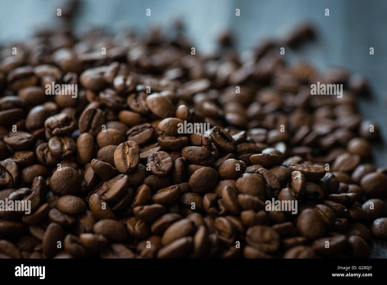 Roasted coffee beans on a rustic wooden table Stock Photo - Alamy