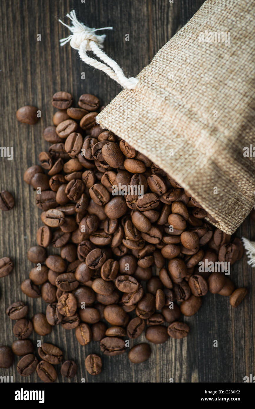 Roasted coffee beans on a rustic wooden table Stock Photo - Alamy