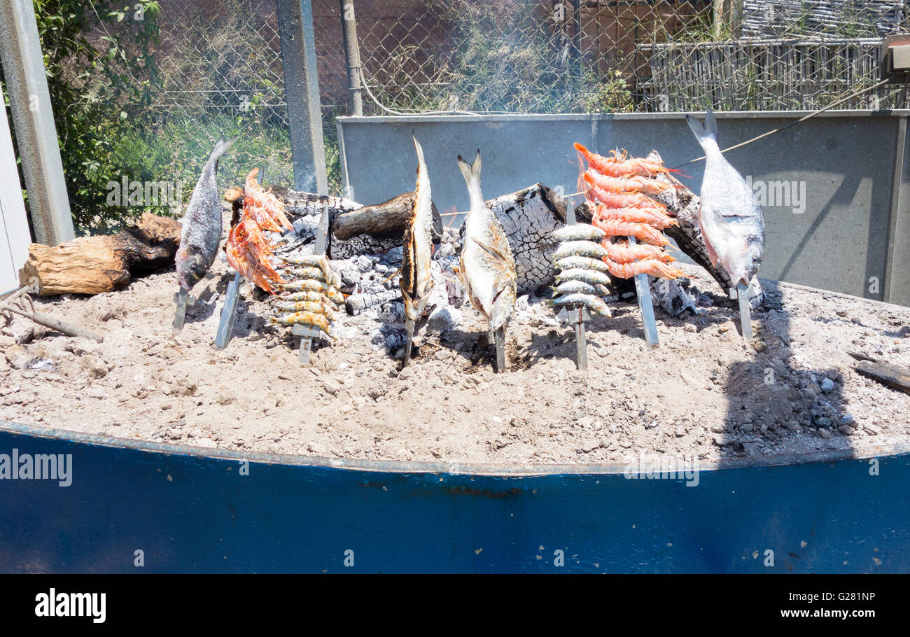 Fish being grilled at a beach front restaurant on the Costa Del Sol ...
