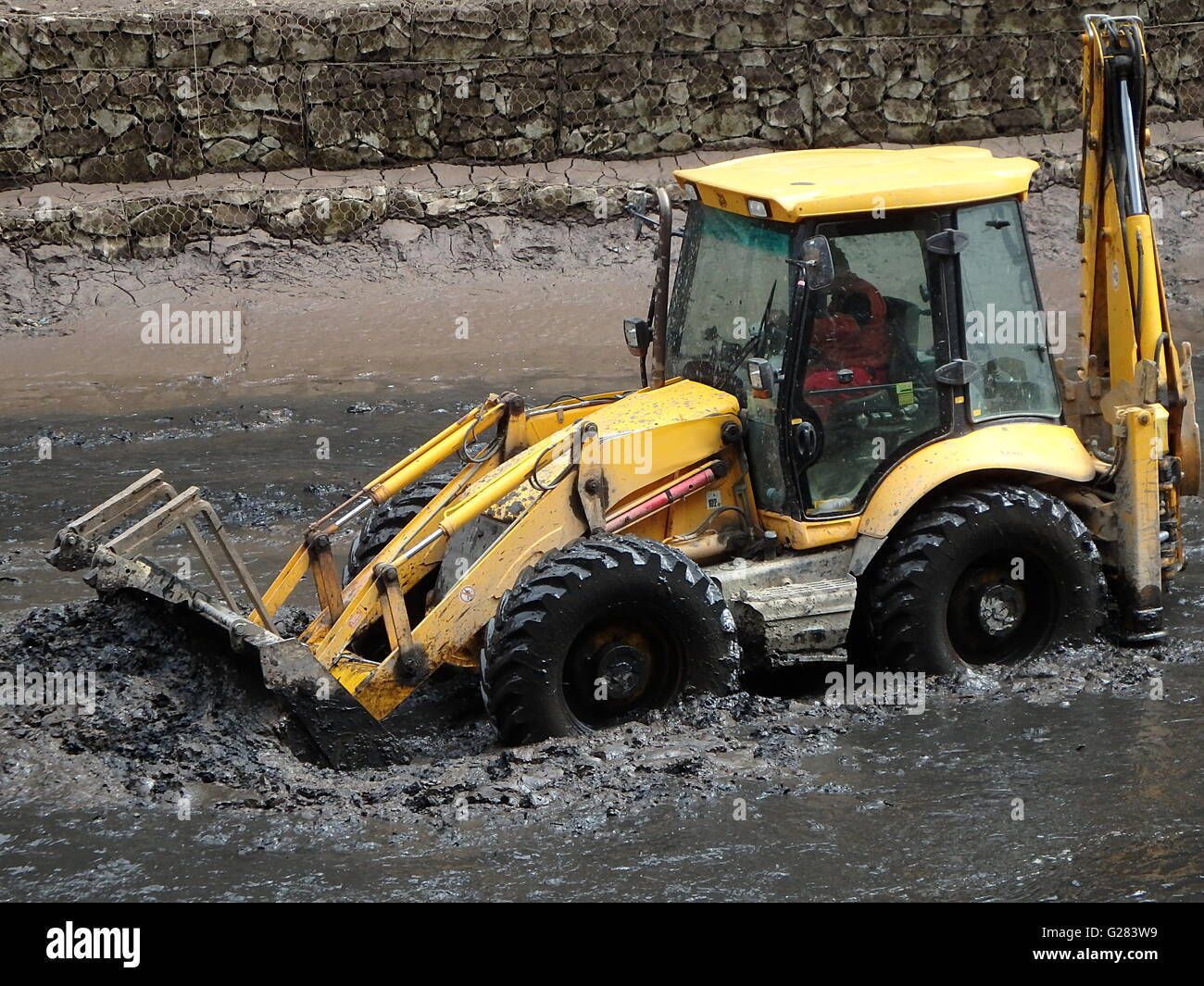 yellow wheel loader excavator in mud Stock Photo - Alamy