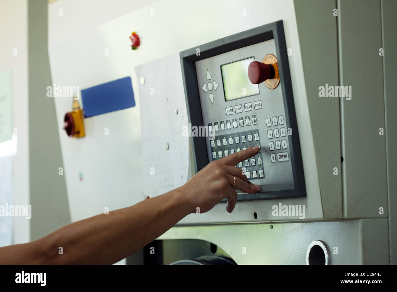 Man presses button on electronic control panel Stock Photo - Alamy