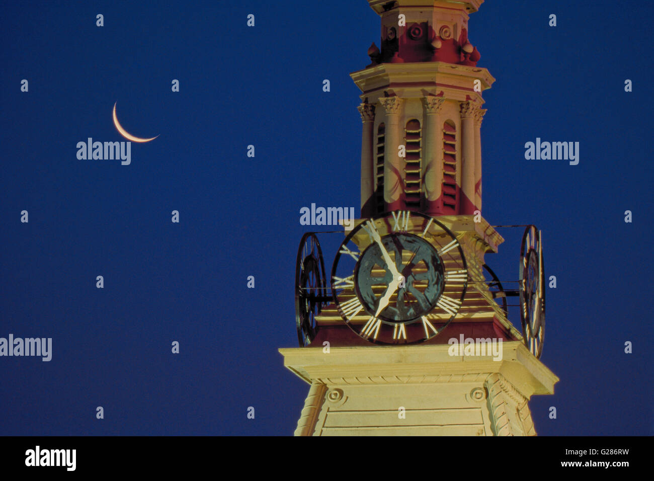 crescent moon over an old clock tower at the train station in helena ...