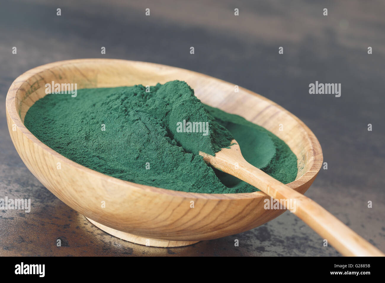 Spirulina Algae Powder, close up. Spirulina powder in wooden bowl with ...
