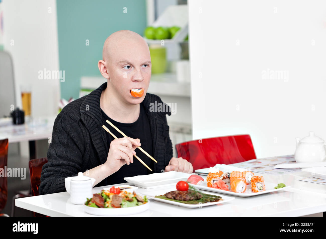Handsome man eating sushi hi-res stock photography and images - Alamy