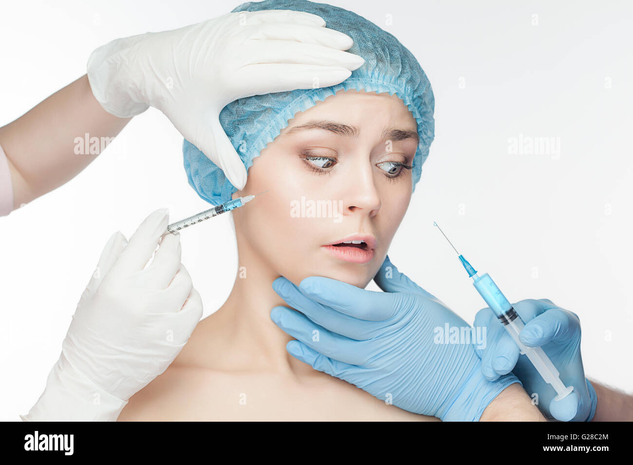 Attractive woman at plastic surgery with syringe in her face Stock ...