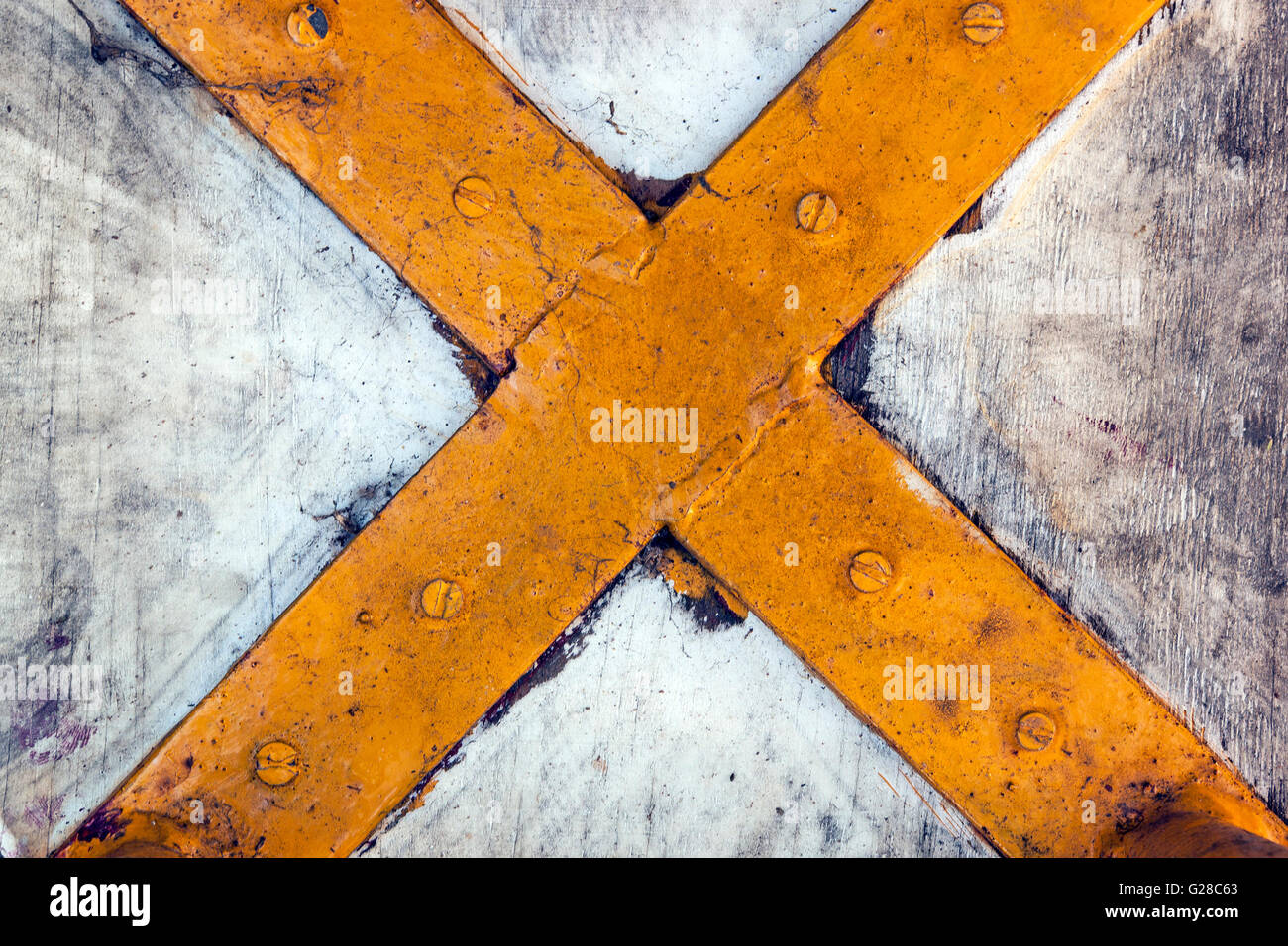 Rustic Yellow metal cross screwed onto grungy white painted wooden ...