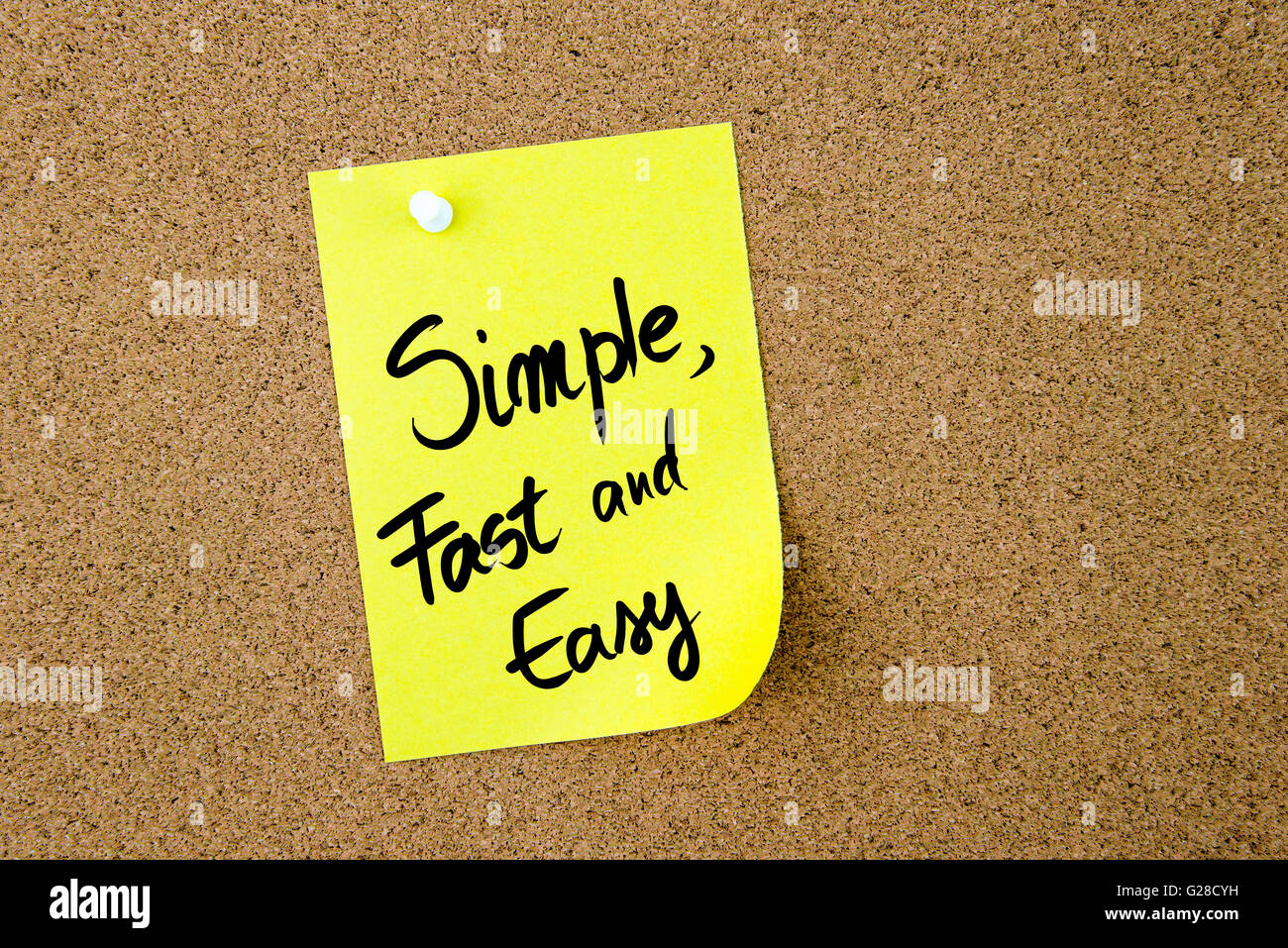 Simple, Fast and Easy written on yellow paper note pinned on cork board ...